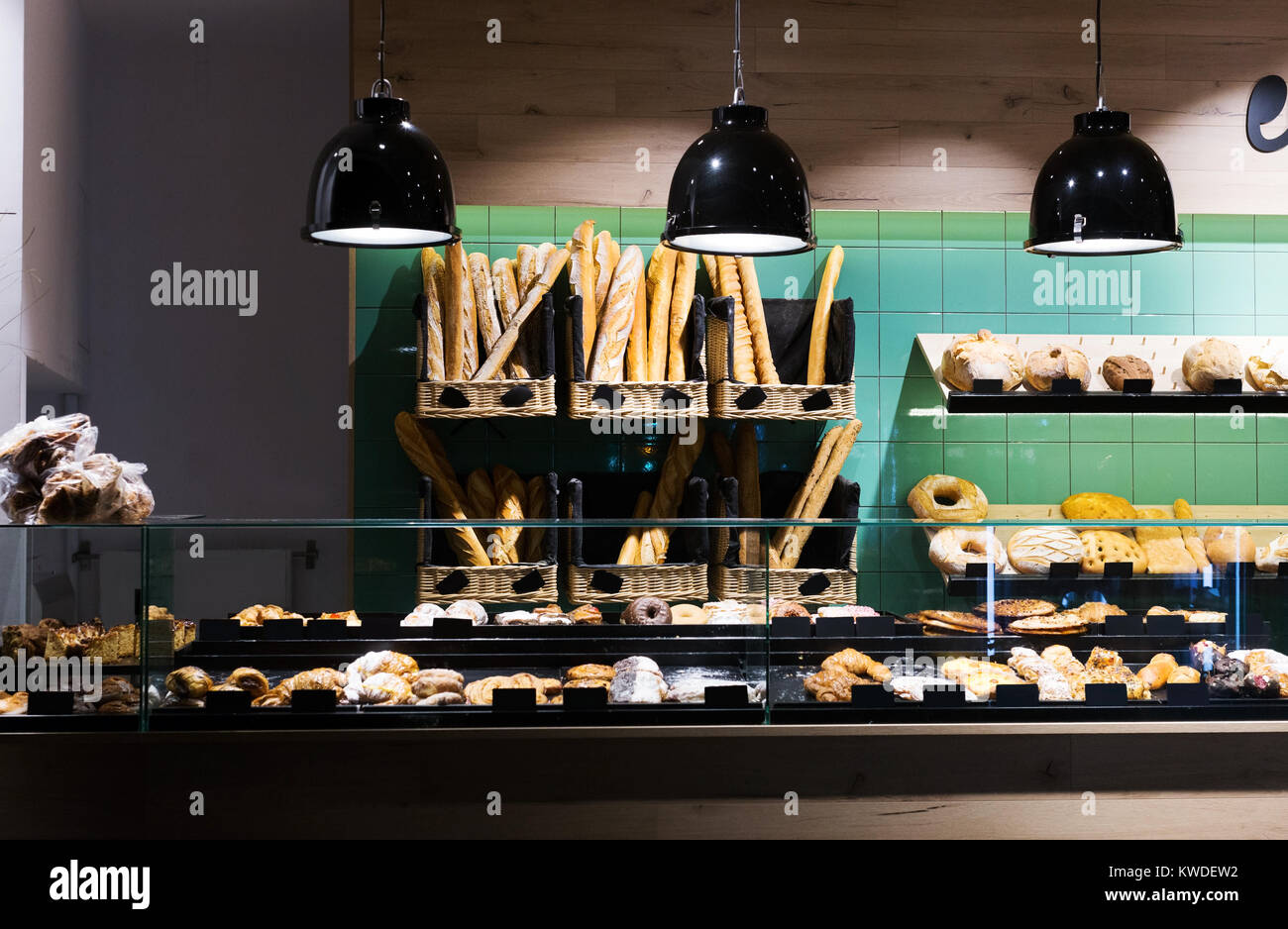 view on bakery counter with many different pastries and bread displayed ...