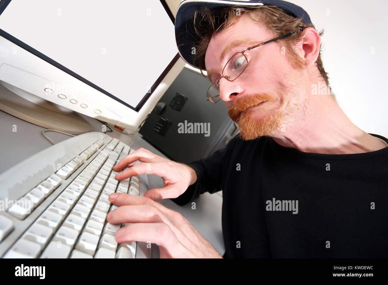 mad programmer sitting at a computer desk Stock Photo - Alamy