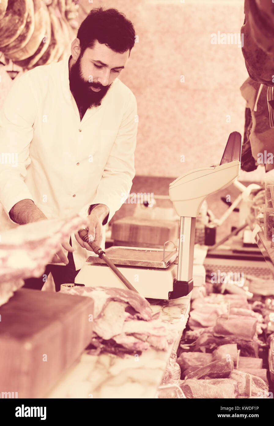 arab shop assistant carving meat to sell in butcher’s shop Stock Photo ...