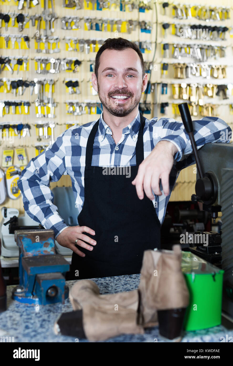 Smiling man worker preparing his tools for repairing in specialized ...