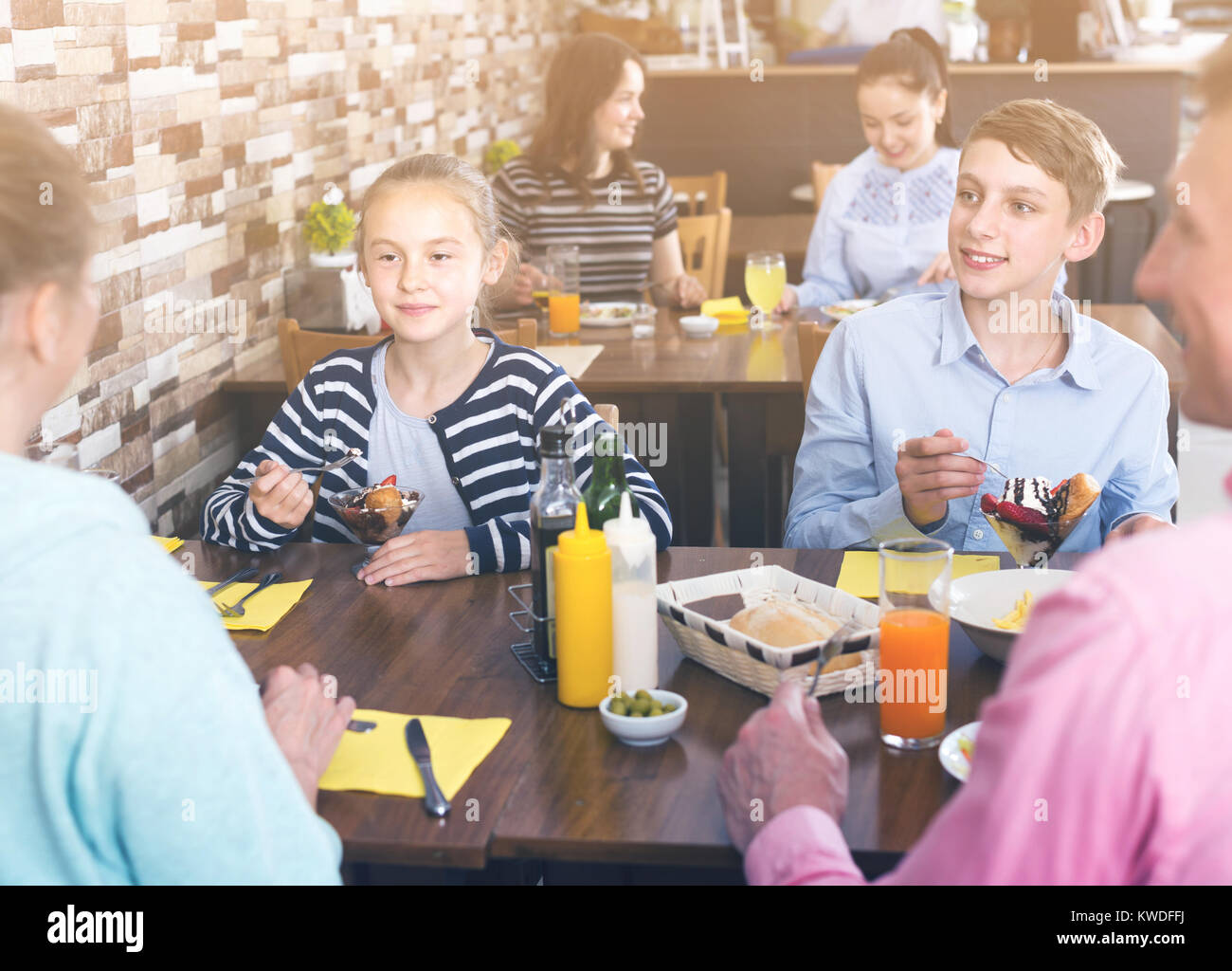 Glad family having lunch in cozy cafe Stock Photo - Alamy