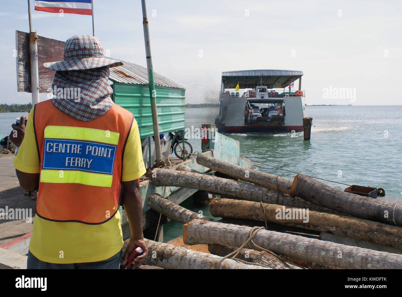 Worker in port with ferry, Thailand Stock Photo - Alamy