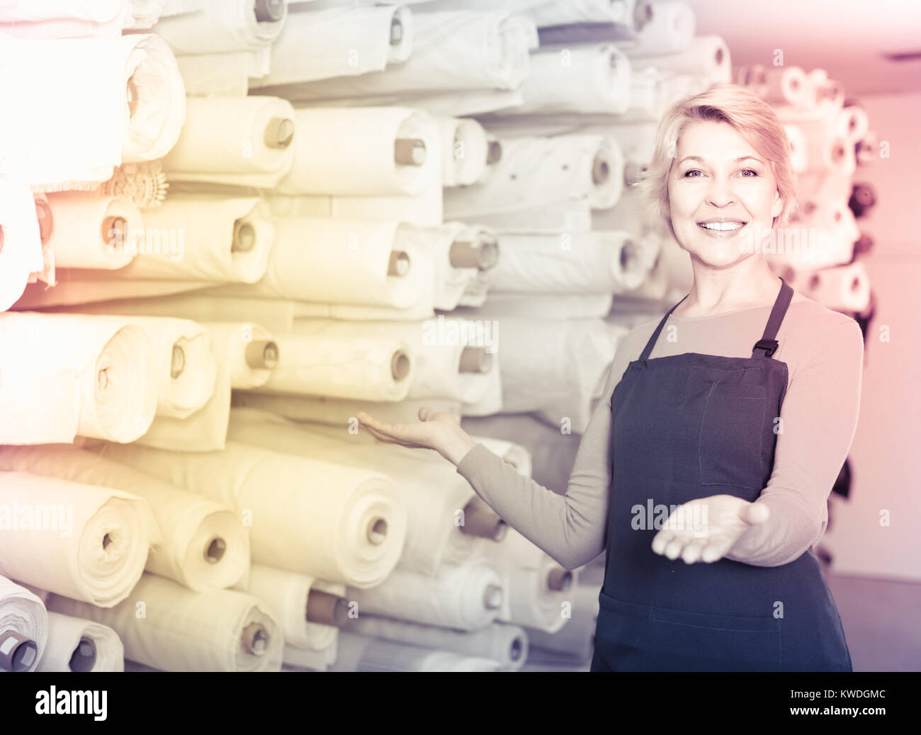 happy european female shop assistant demonstrating assortment at ...