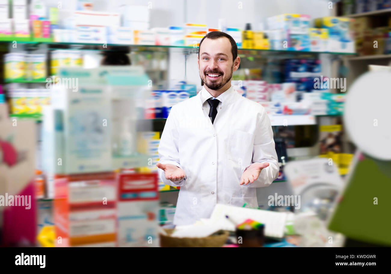 Handsome man pharmacist showing assortment of drugs in pharmacy Stock ...