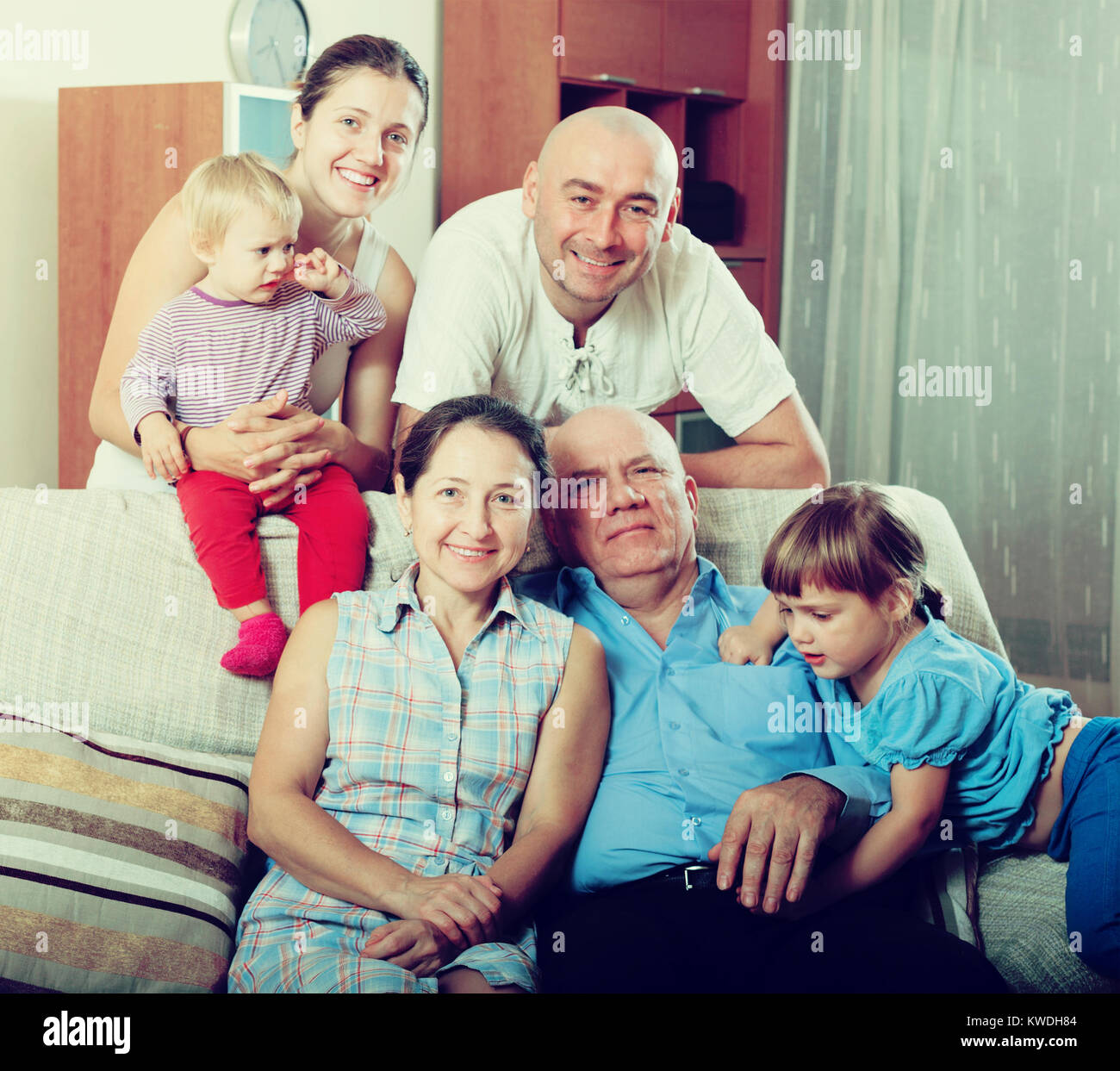 Ordinary three generations family in home Stock Photo - Alamy