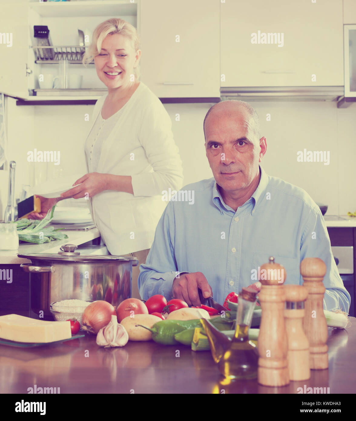 happy senior couple cooking at their kitchen at home Stock Photo - Alamy