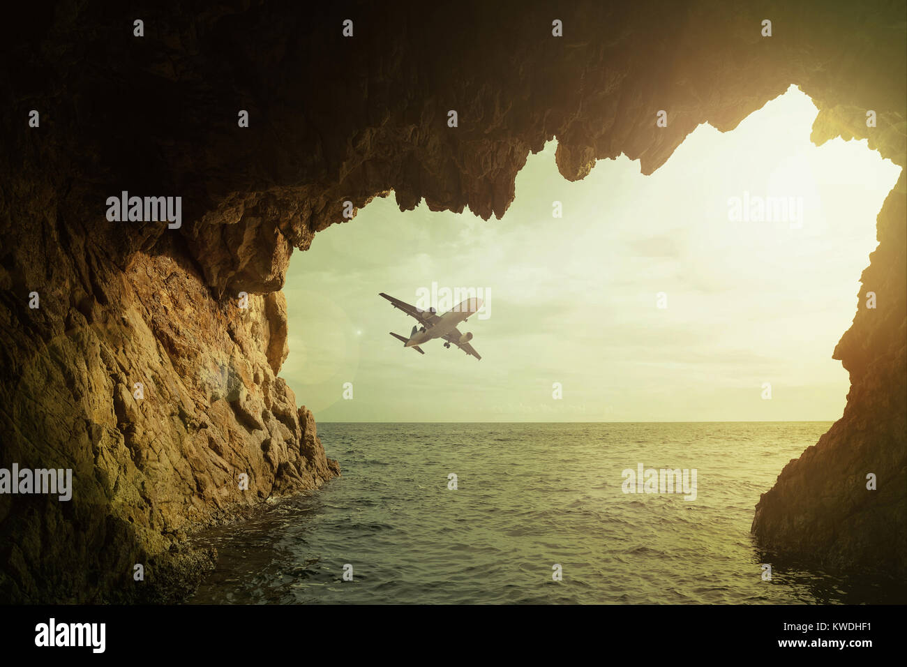 Airplane flying high in the sky above water surface Stock Photo - Alamy