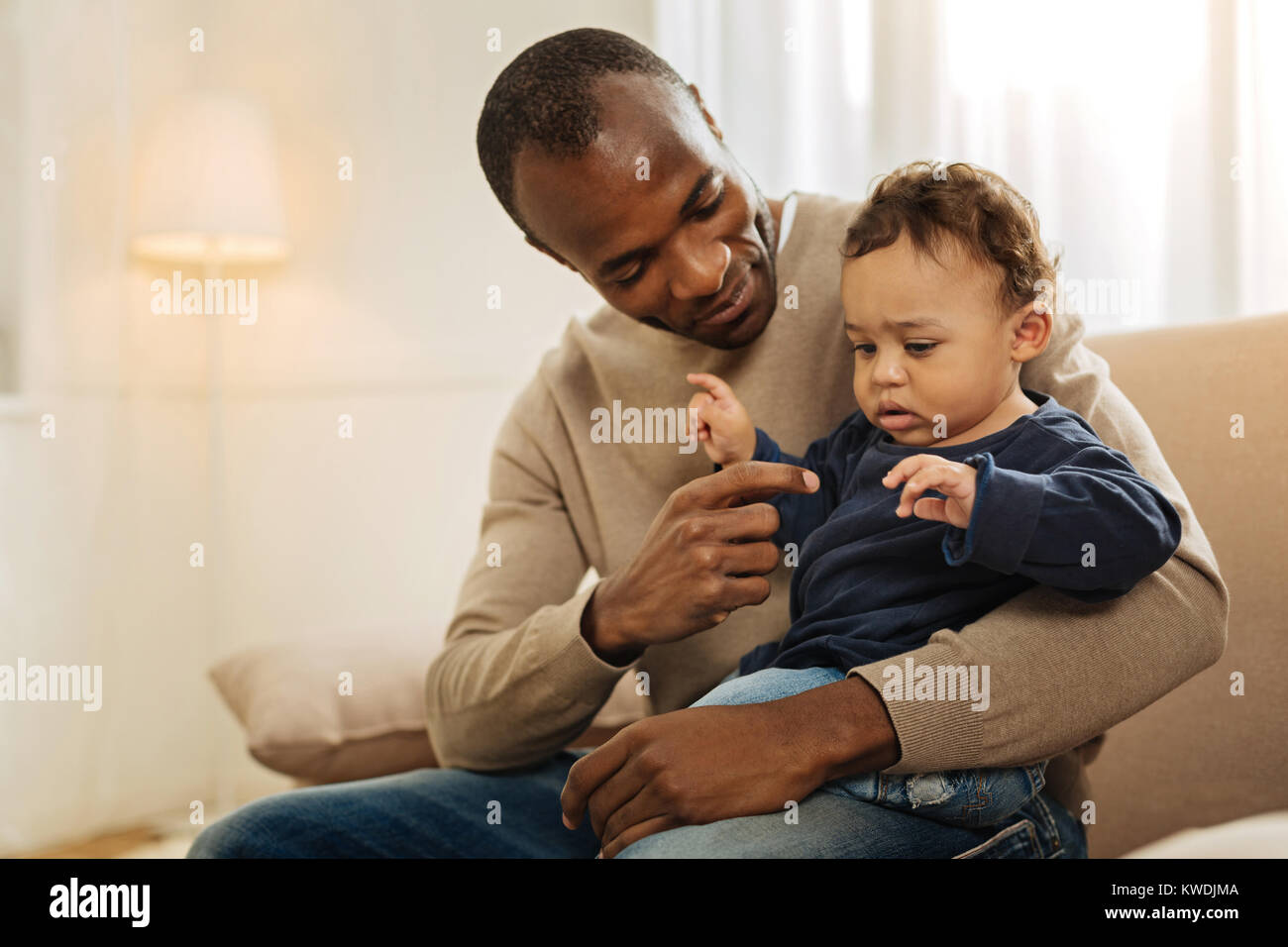 Alert man playing with his child Stock Photo - Alamy