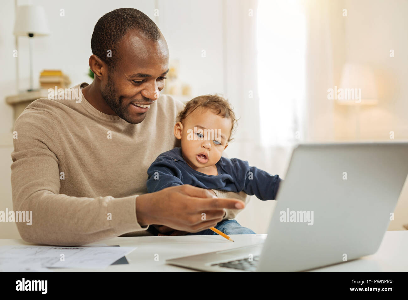 Smiling daddy amusing his son Stock Photo - Alamy
