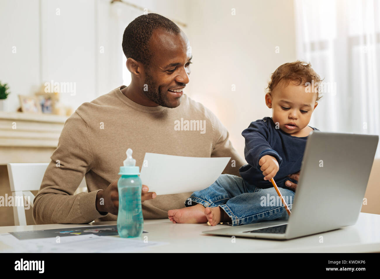 Sweet child working with his daddy Stock Photo - Alamy