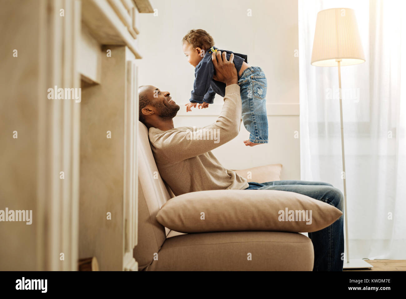 Devoted father spending time with his baby Stock Photo - Alamy