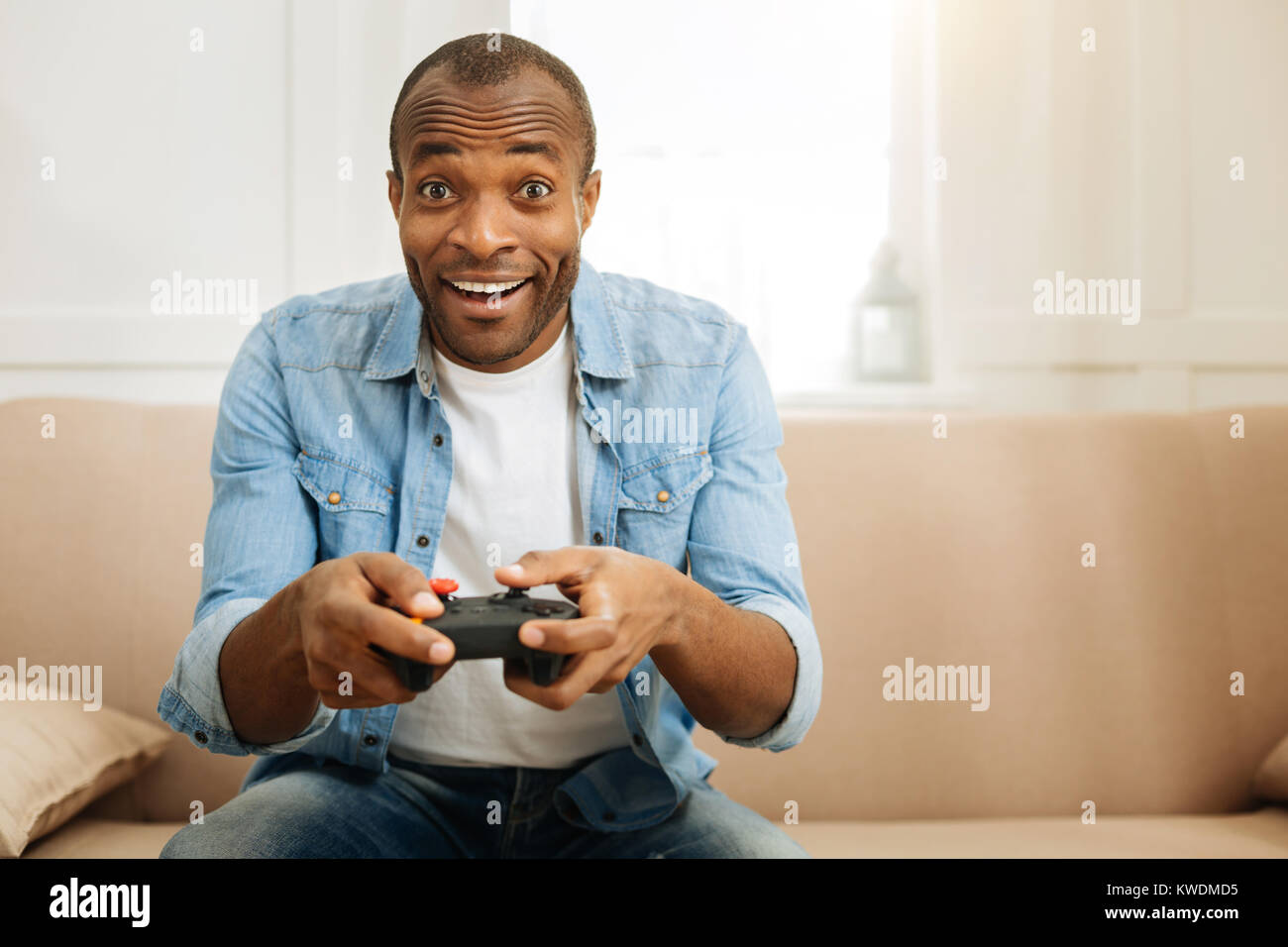 Joyful man playing and relaxing Stock Photo - Alamy