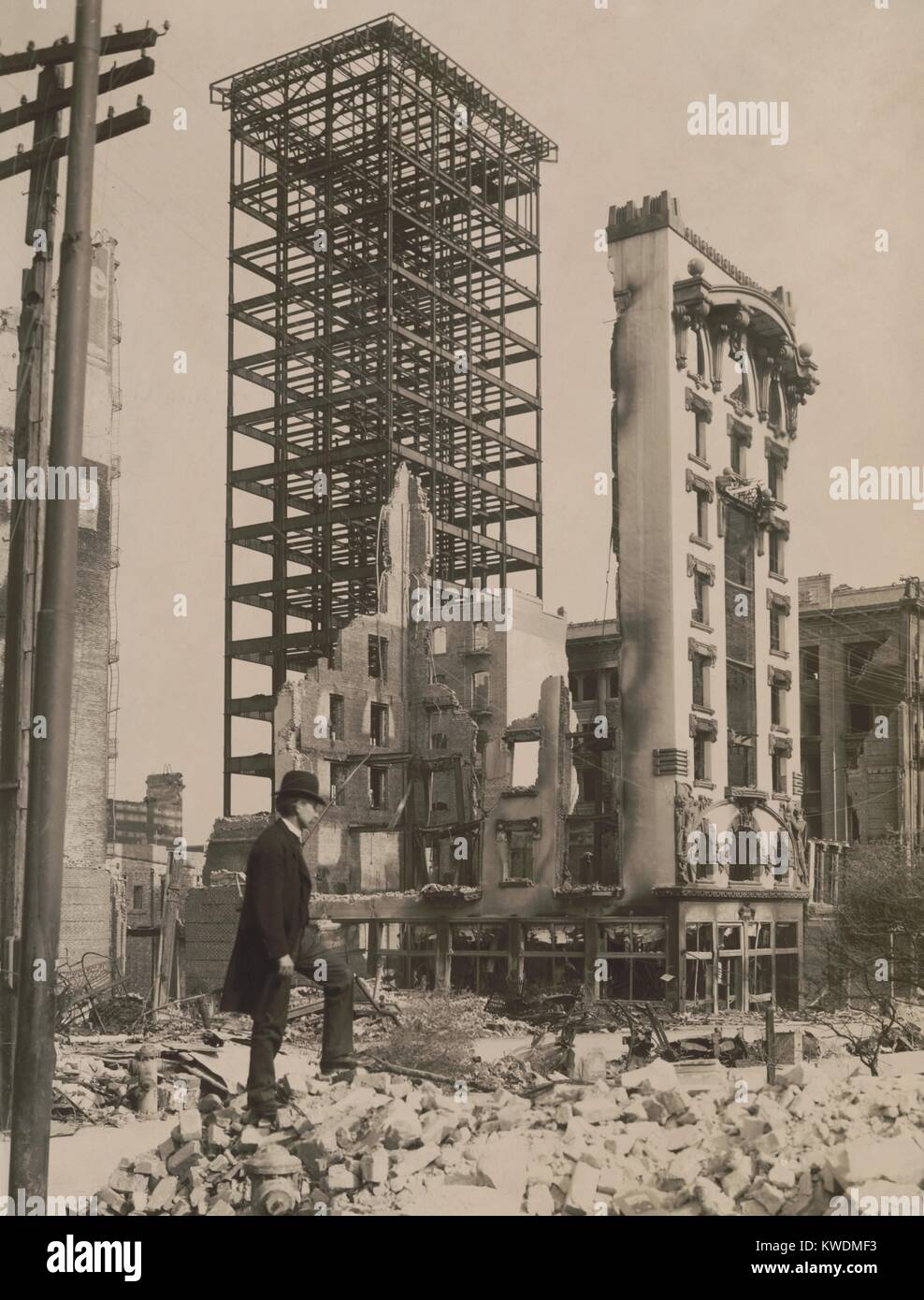 After the April 18, 1906 San Francisco earthquake, a man stands among ...