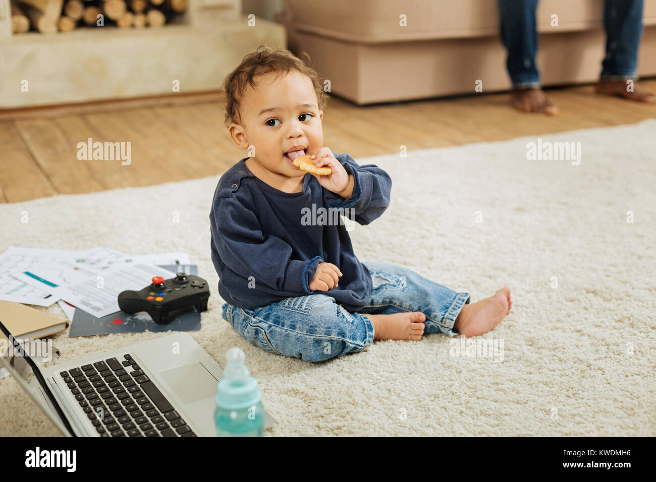 Adorable baby having cookies on the floor Stock Photo - Alamy