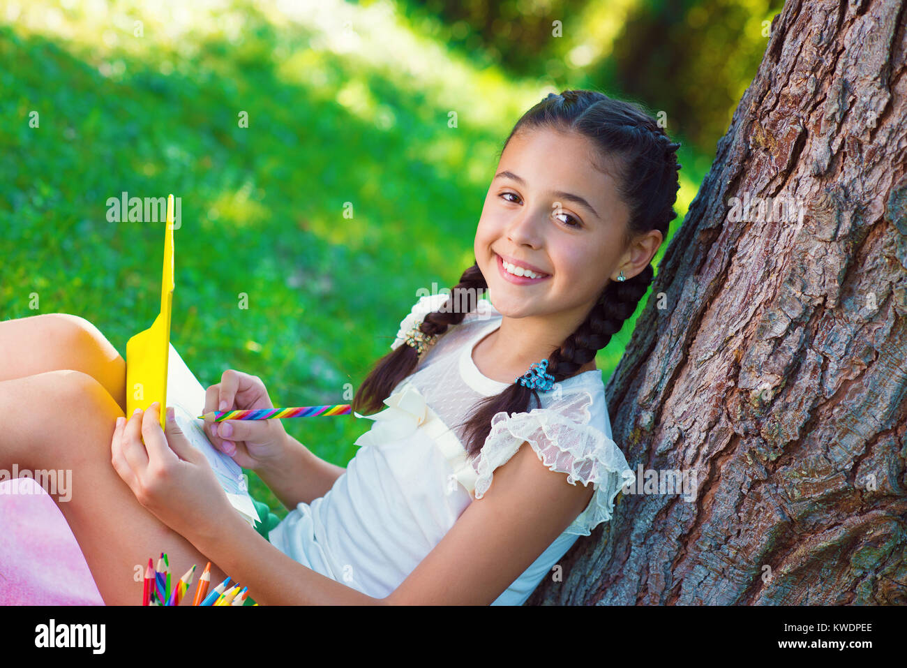 Happy beautiful girl back to school and learning Stock Photo - Alamy