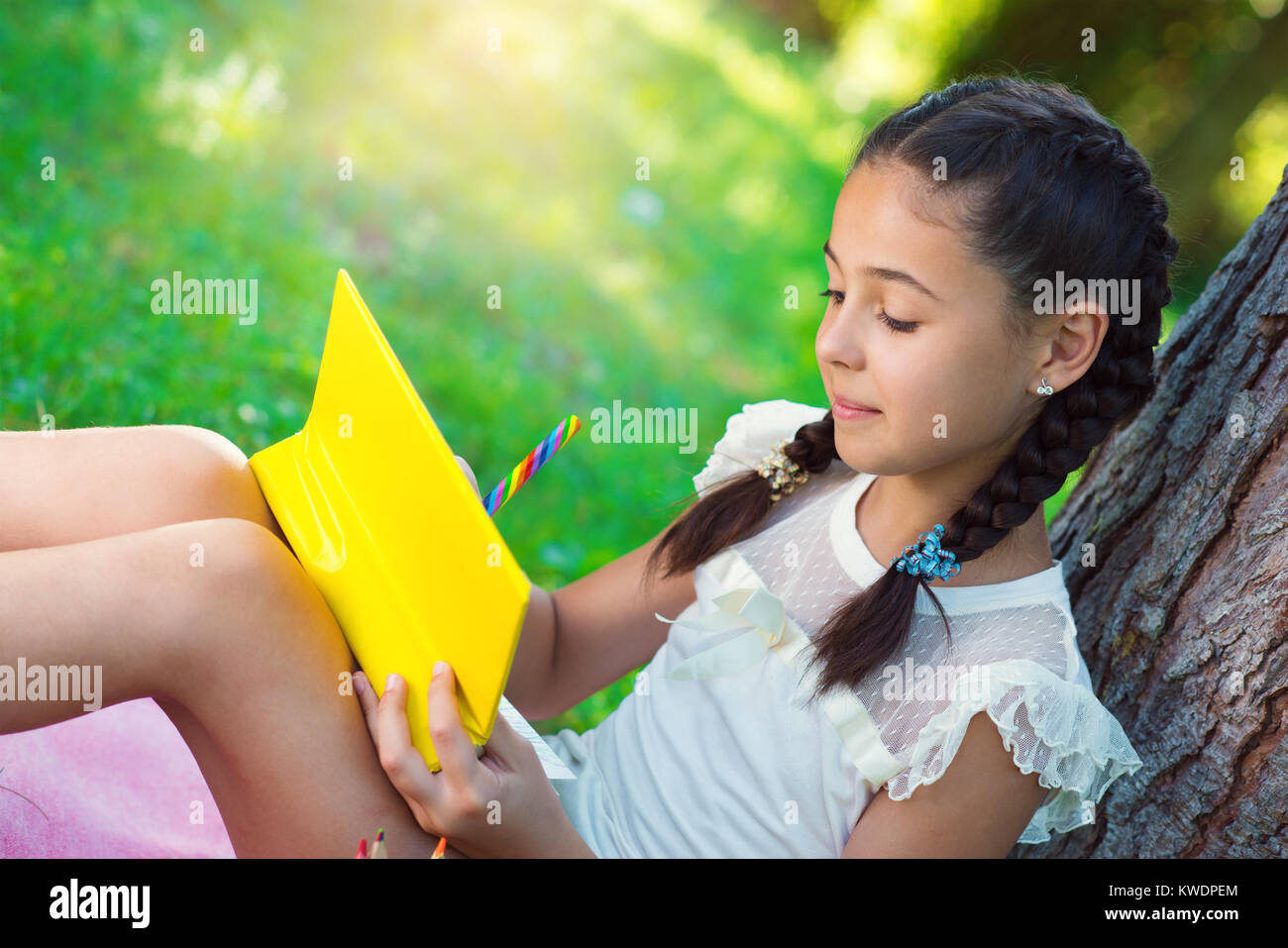 Happy beautiful girl back to school and learning Stock Photo - Alamy
