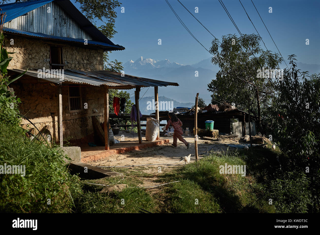 Little Nepali girl running in farm courtyard, Dulikhel, Katmandu Valley ...