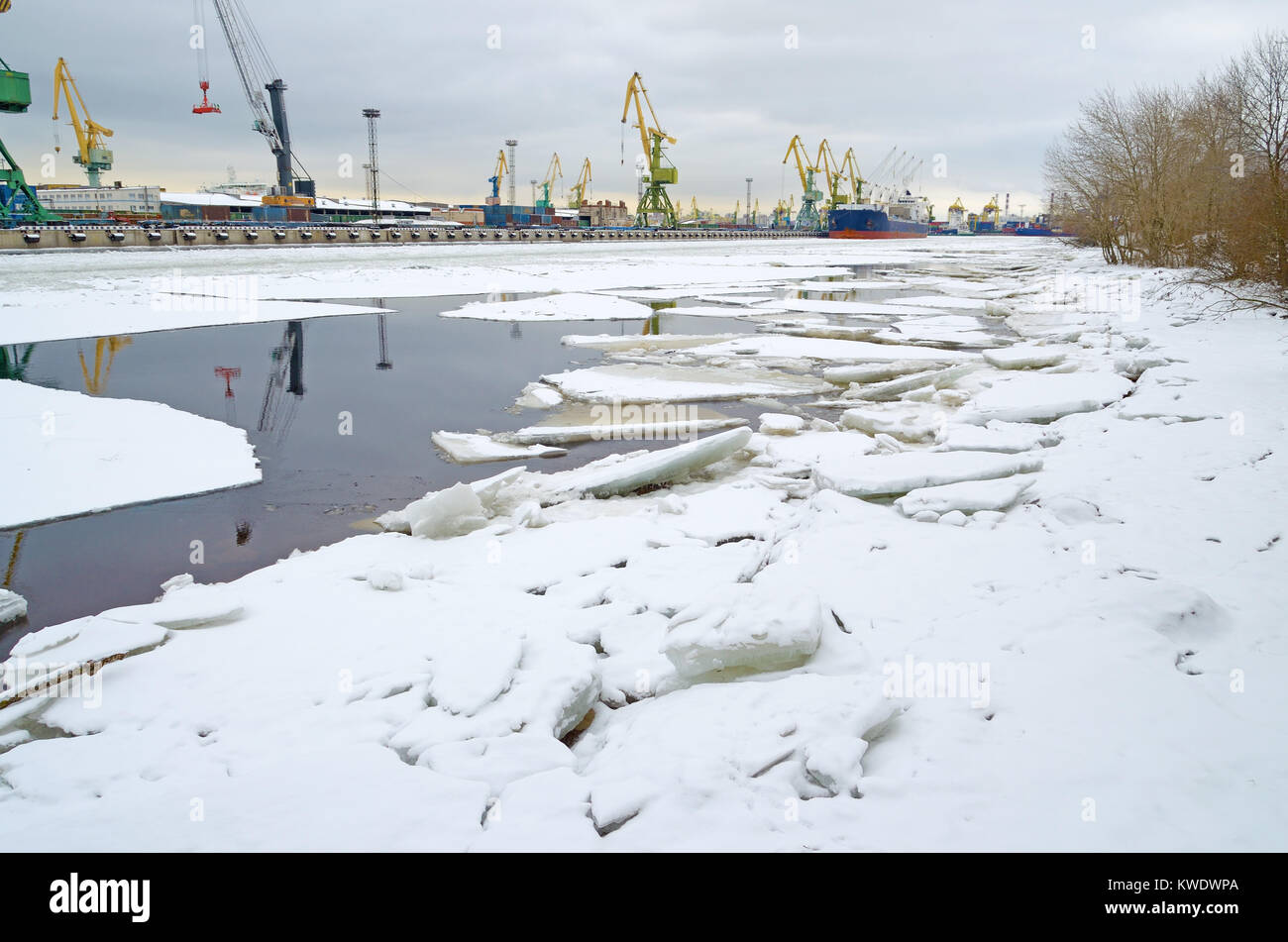 In the port of the river is covered with ice.The ships are berthed.Them ...