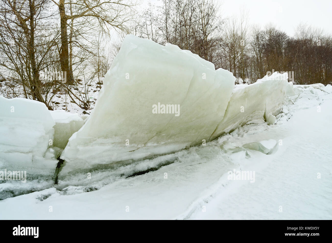 A large block of ice on the shore.White ice is very large Stock Photo ...