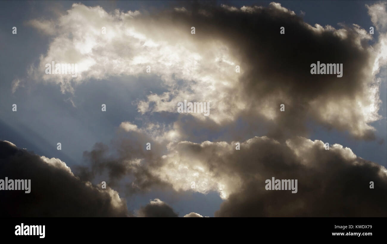 Thick brooding clouds with light illuminating through Stock Photo - Alamy