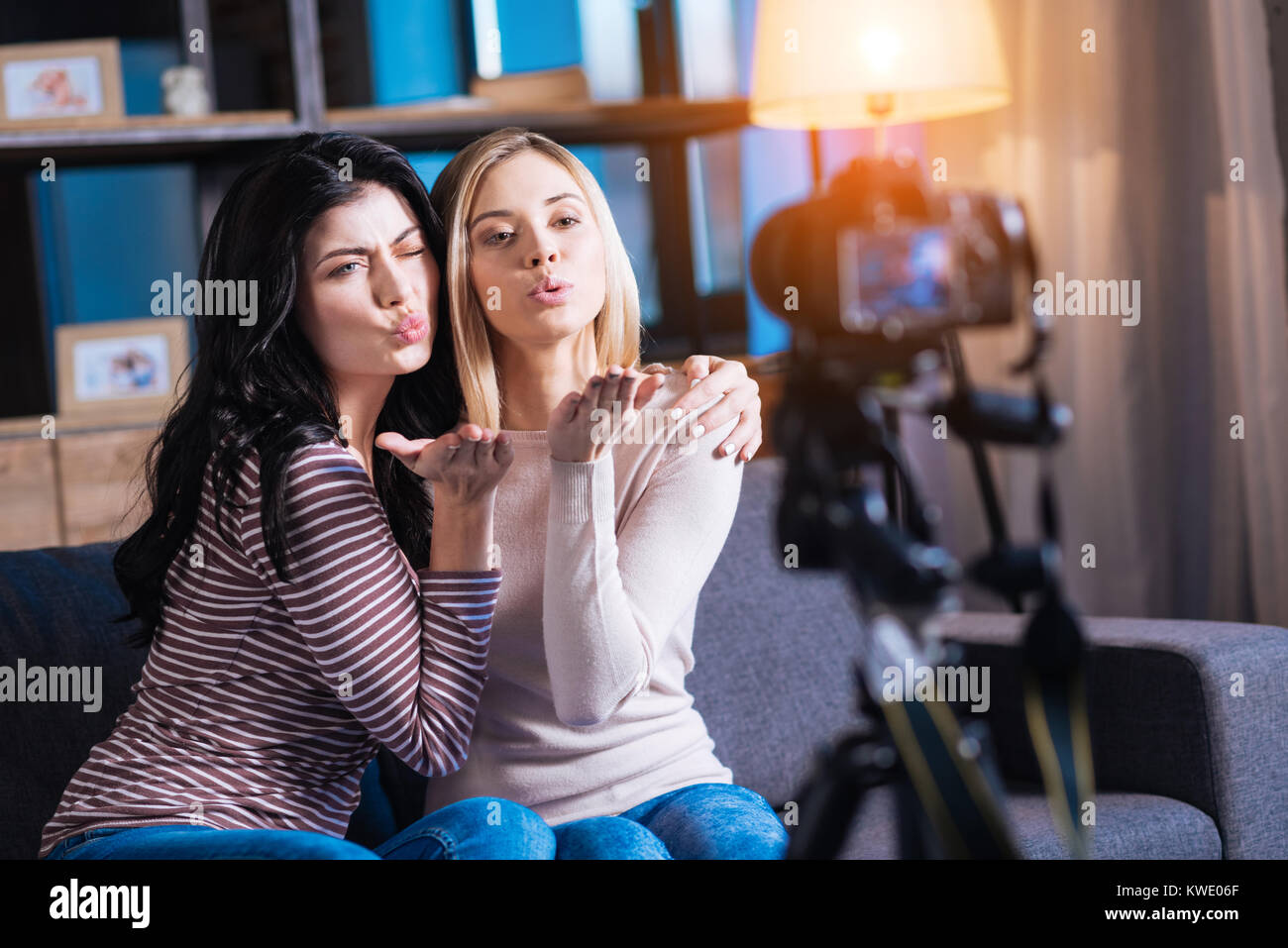 Positive young women sending a kiss Stock Photo - Alamy