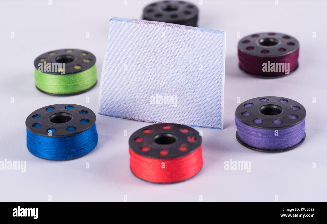 metal sewing rollers and colored yarns Stock Photo - Alamy