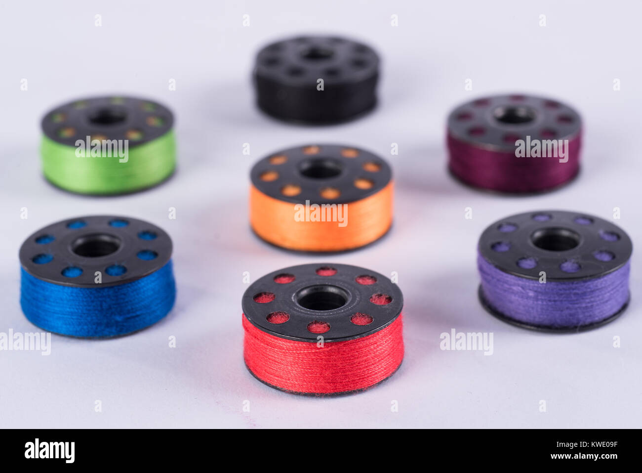 metal sewing rollers and colored yarns Stock Photo - Alamy