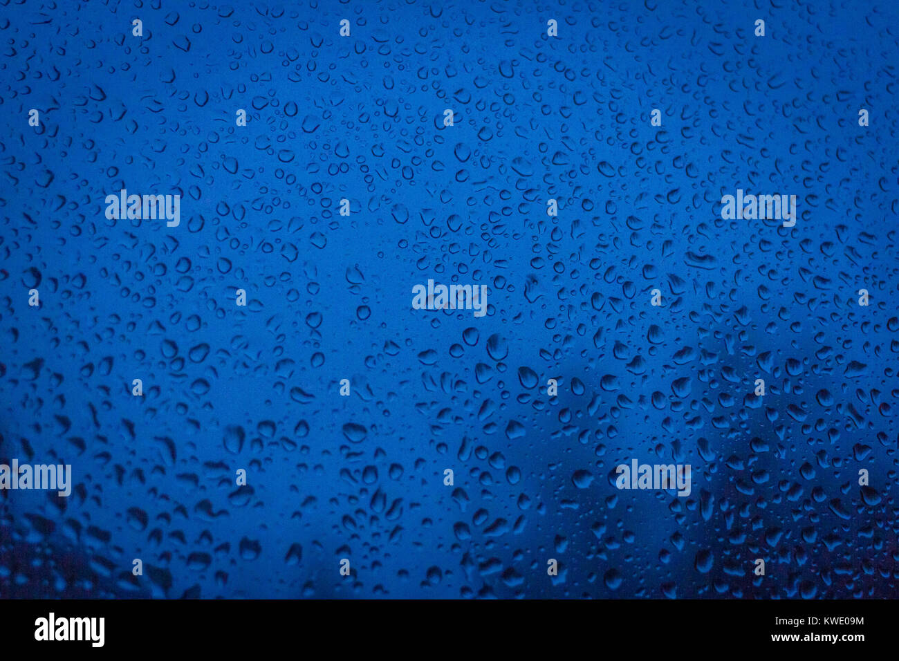 Texture drops and glass. Blue background, night Stock Photo - Alamy