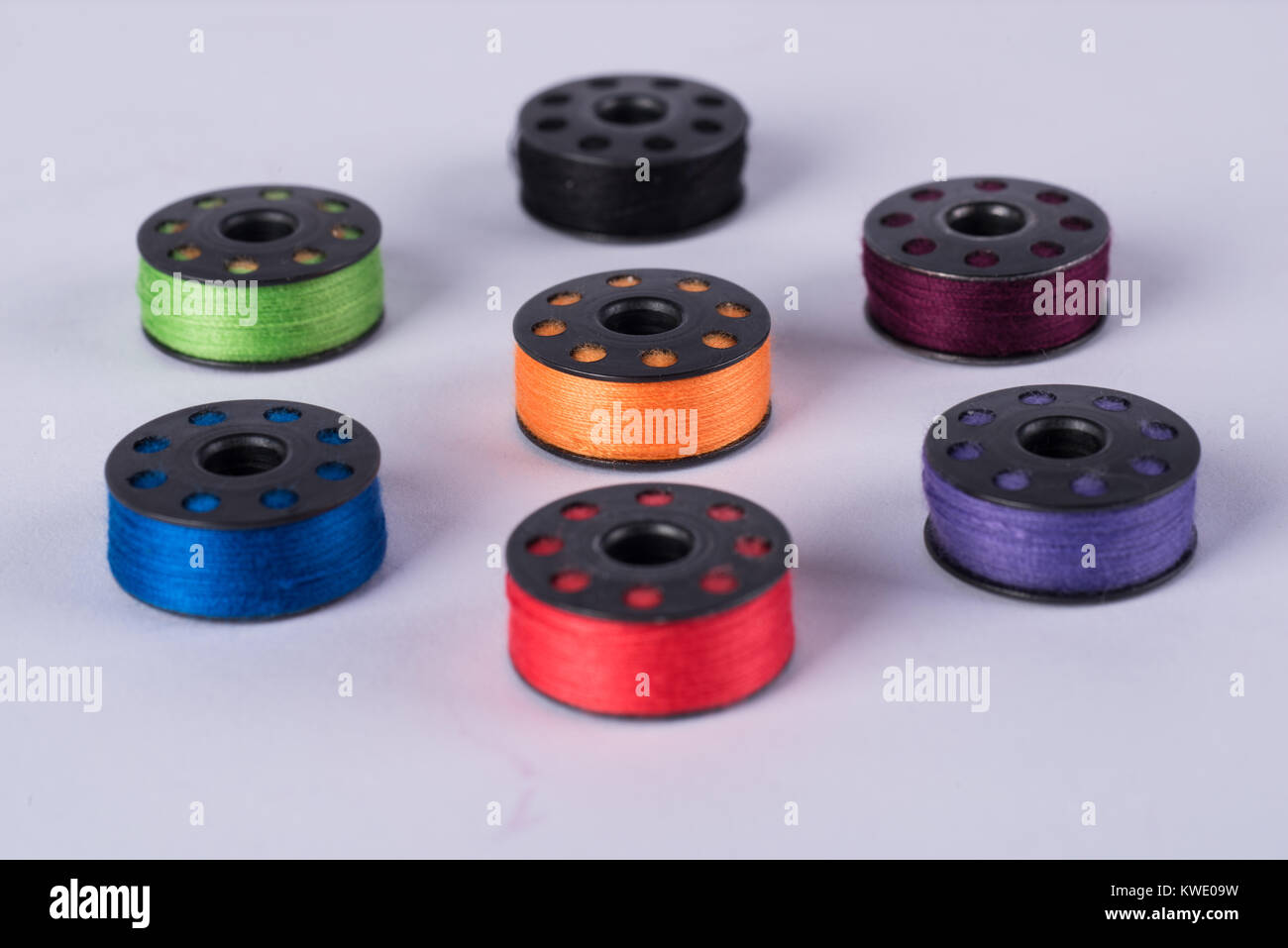 metal sewing rollers and colored yarns Stock Photo - Alamy
