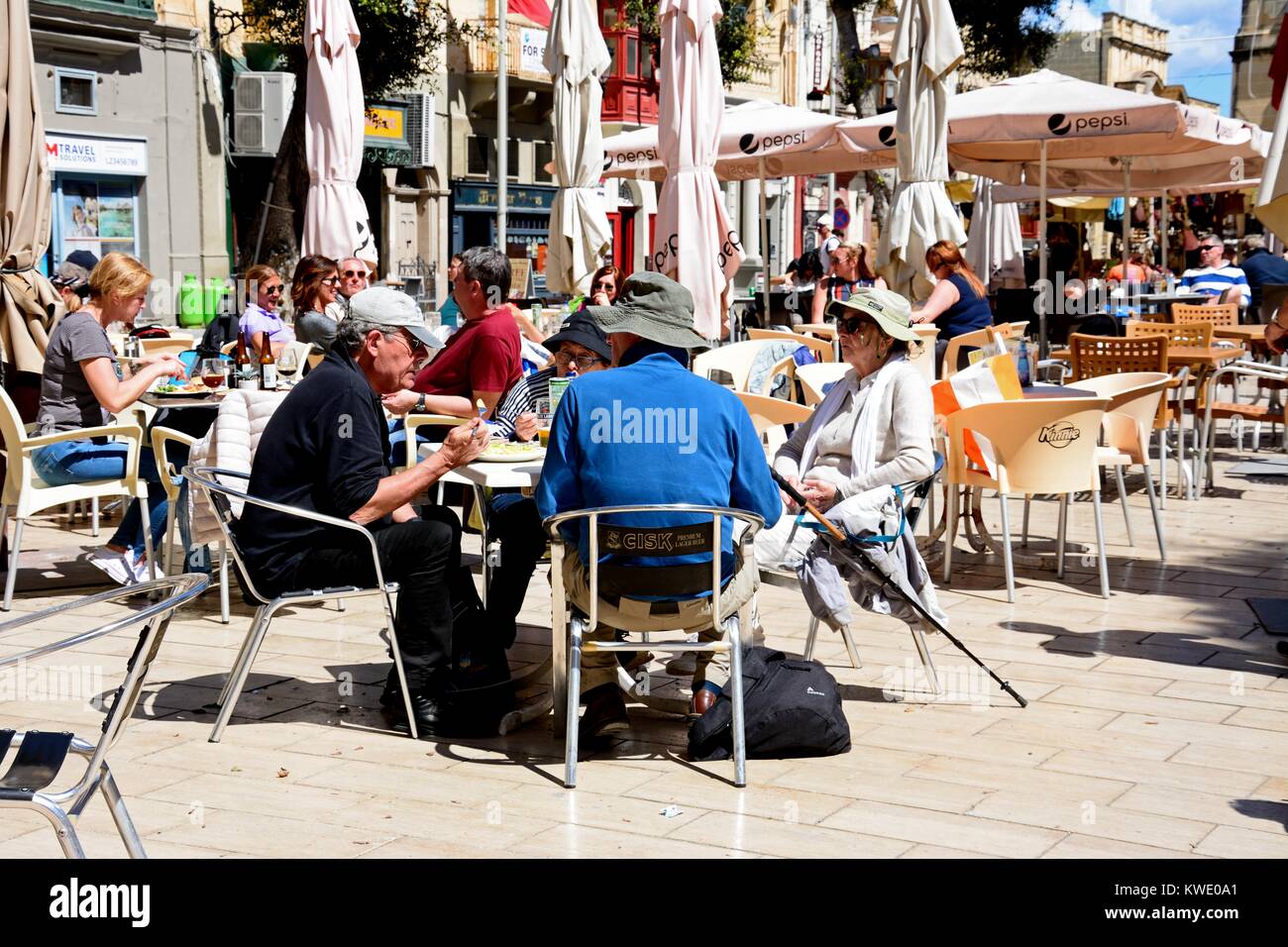 People relaxing at pavement cafes in Independence Square, Victoria ...