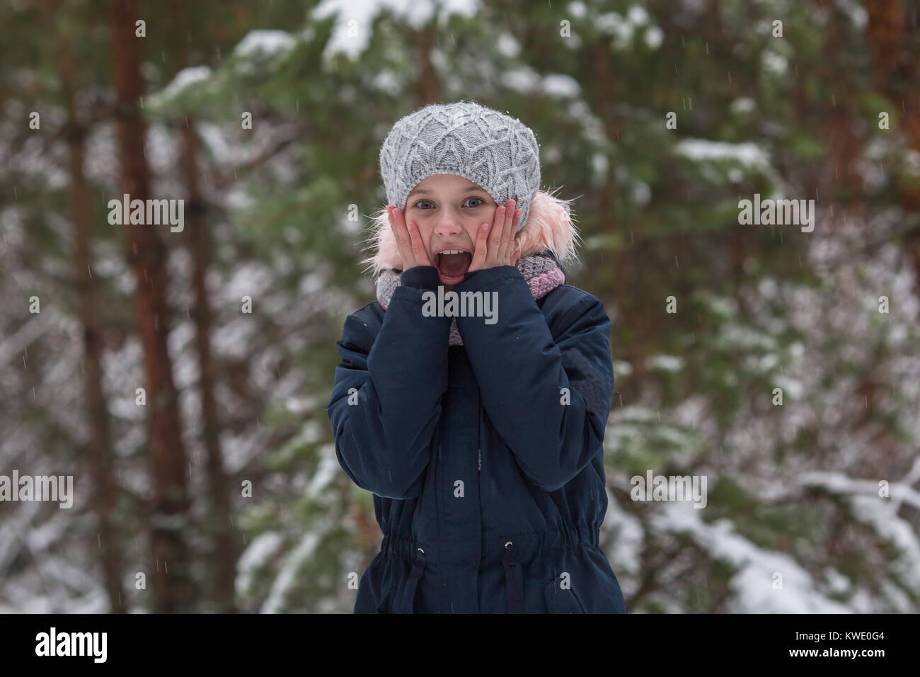 Little girl screaming in a snowy forest Stock Photo - Alamy