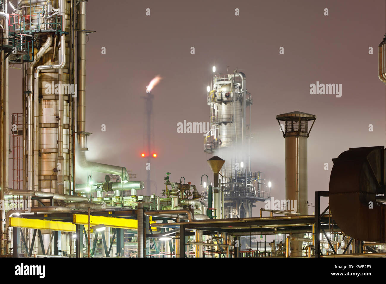 An oil refinery detail shot with a flare in the background Stock Photo ...