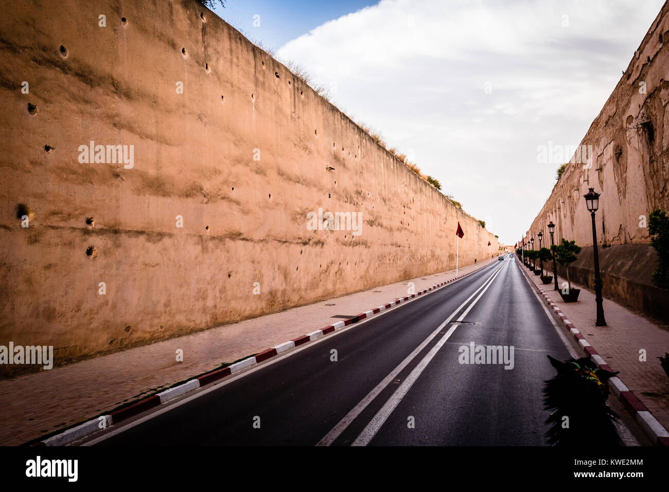 Road by walls in city Stock Photo - Alamy
