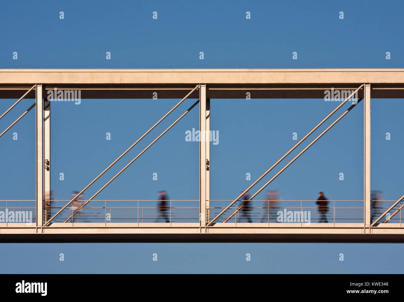 A modern pedestrian bridge between two office buildings with slightly ...