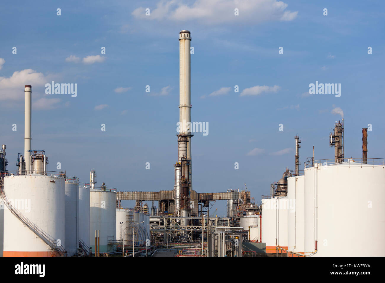 Some storage tanks and smoke stacks in a large refinery Stock Photo - Alamy