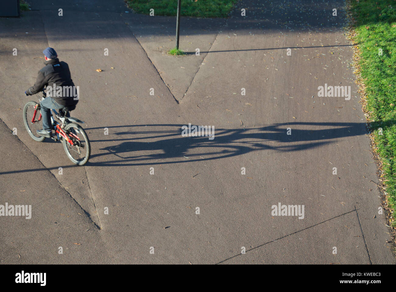 cyclist casting shadow Stock Photo - Alamy