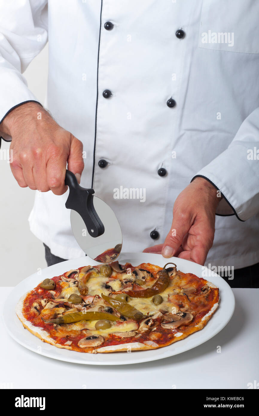 Restaurant kitchen chef decorating pizza hi-res stock photography and ...