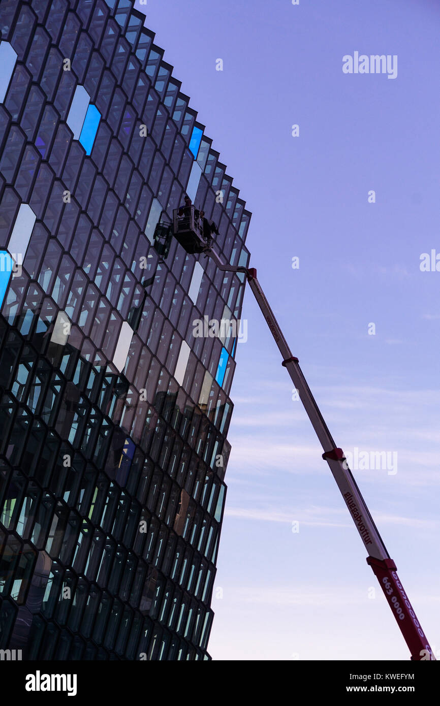 Cleaning of the glass facade of Harpa concert hall in Reykjavik ...