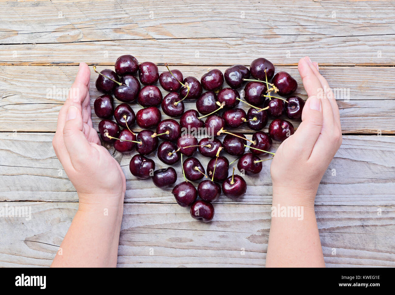 Cherries in womens hand hi-res stock photography and images - Alamy