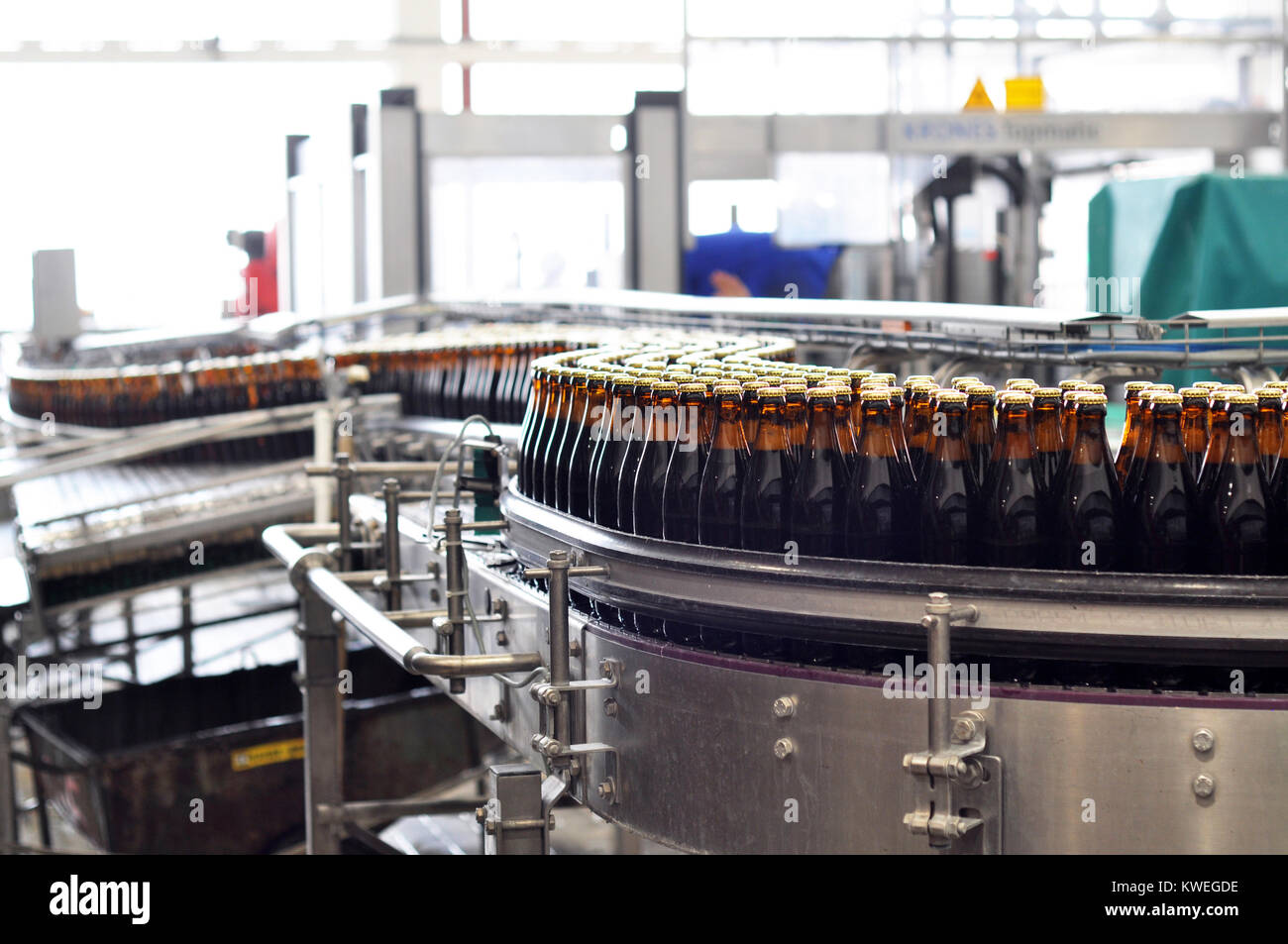beer filling in a brewery - conveyor belt with glass bottles Stock ...