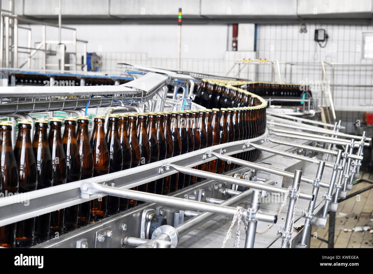 beer filling in a brewery - conveyor belt with glass bottles Stock ...