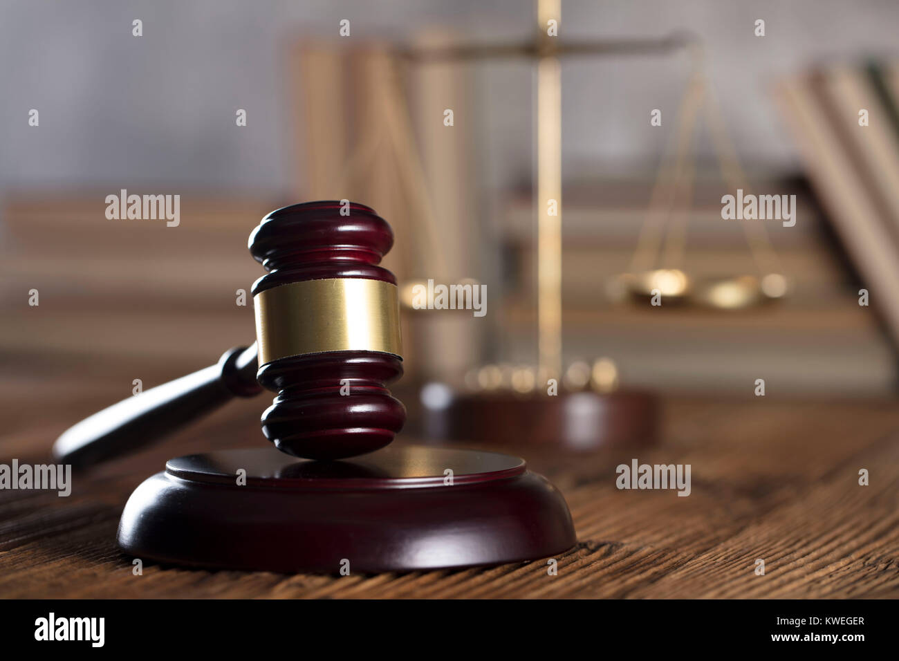 Gavel of judge on rustic wooden table. Bookshelf background Stock Photo ...