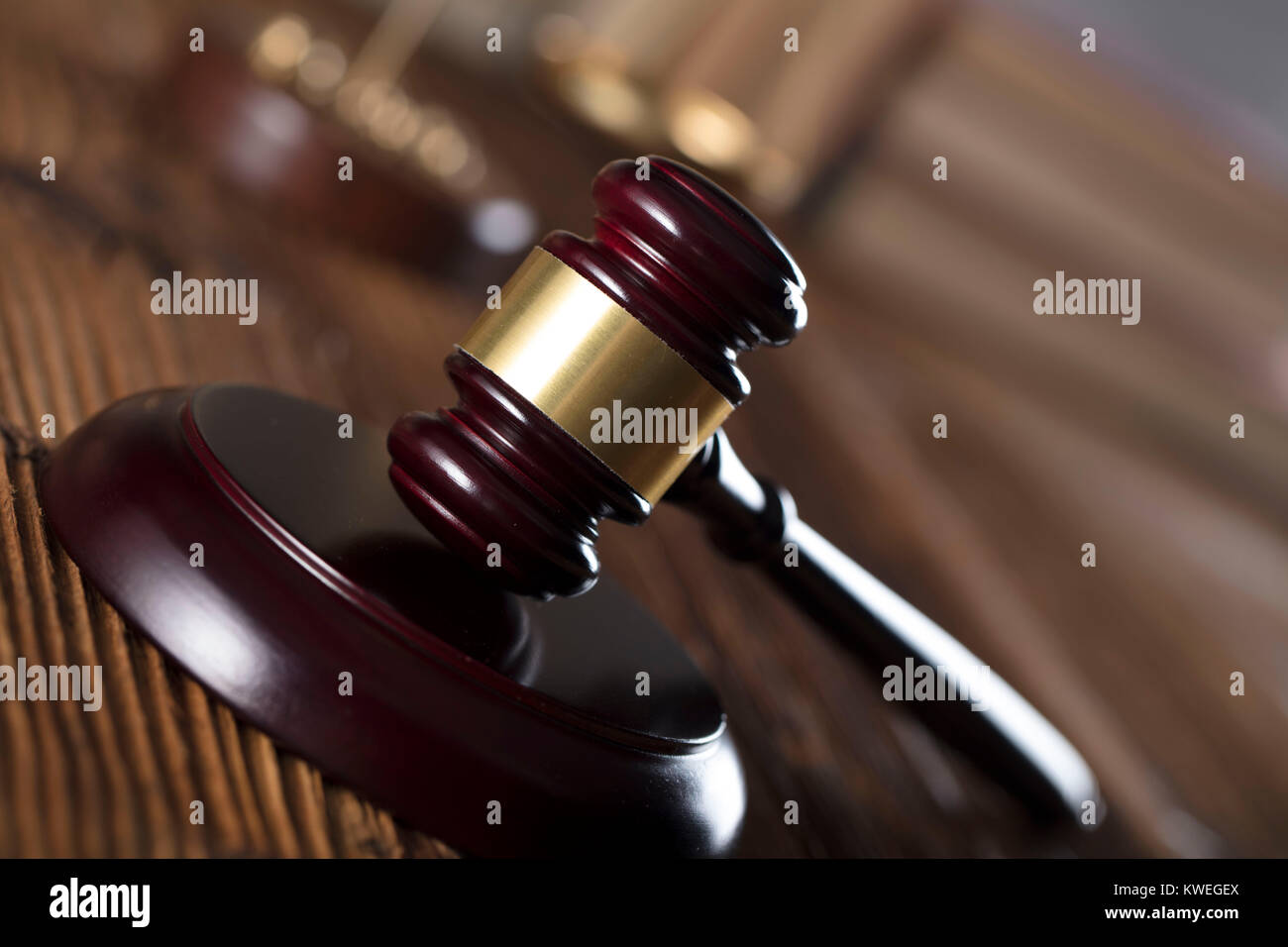 Gavel of judge on rustic wooden table. Bookshelf background Stock Photo ...