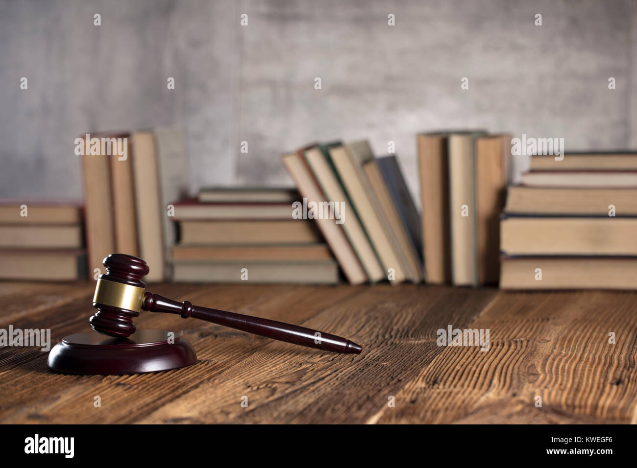 Gavel of judge on rustic wooden table. Bookshelf background Stock Photo ...
