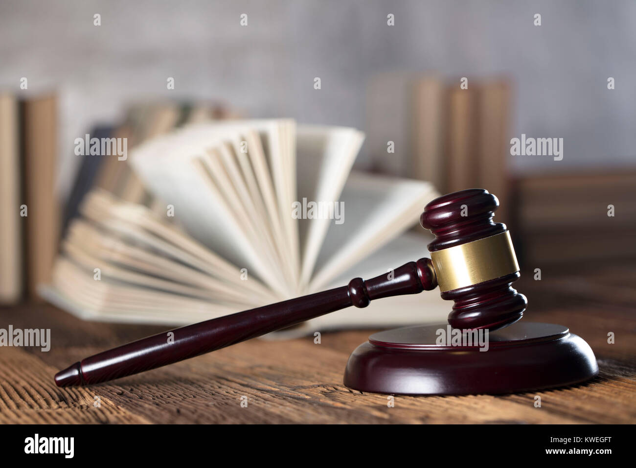 Gavel of judge on rustic wooden table. Bookshelf background Stock Photo ...