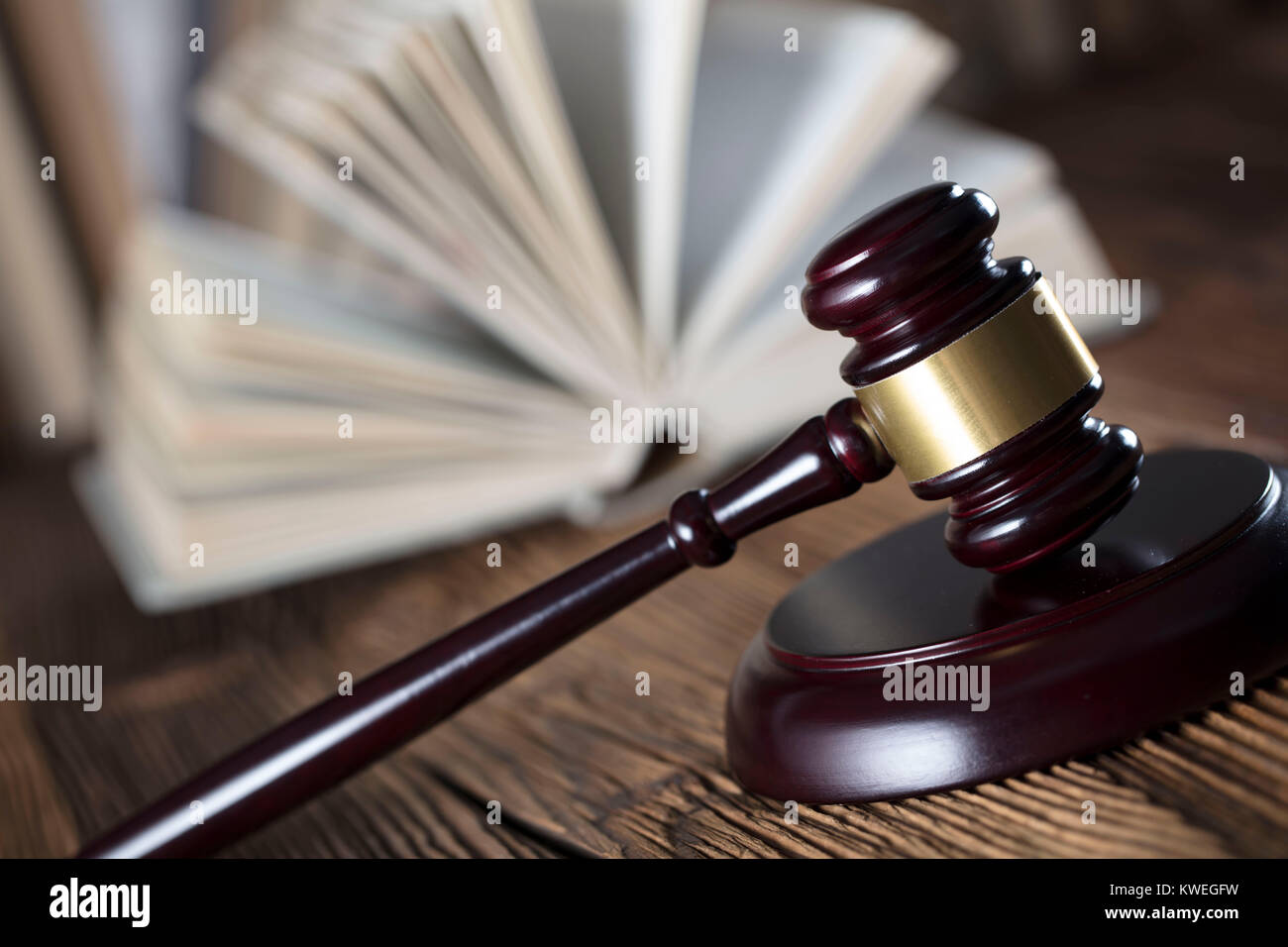 Gavel of judge on rustic wooden table. Bookshelf background Stock Photo ...