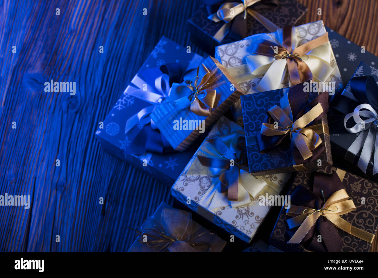 Presents in blue and gold aesthetics, rustic wooden table. Place for ...