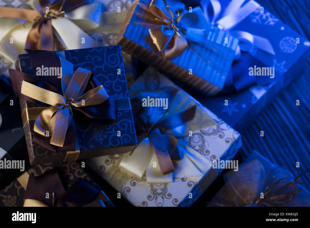 Presents in blue and gold aesthetics, rustic wooden table. Place for ...