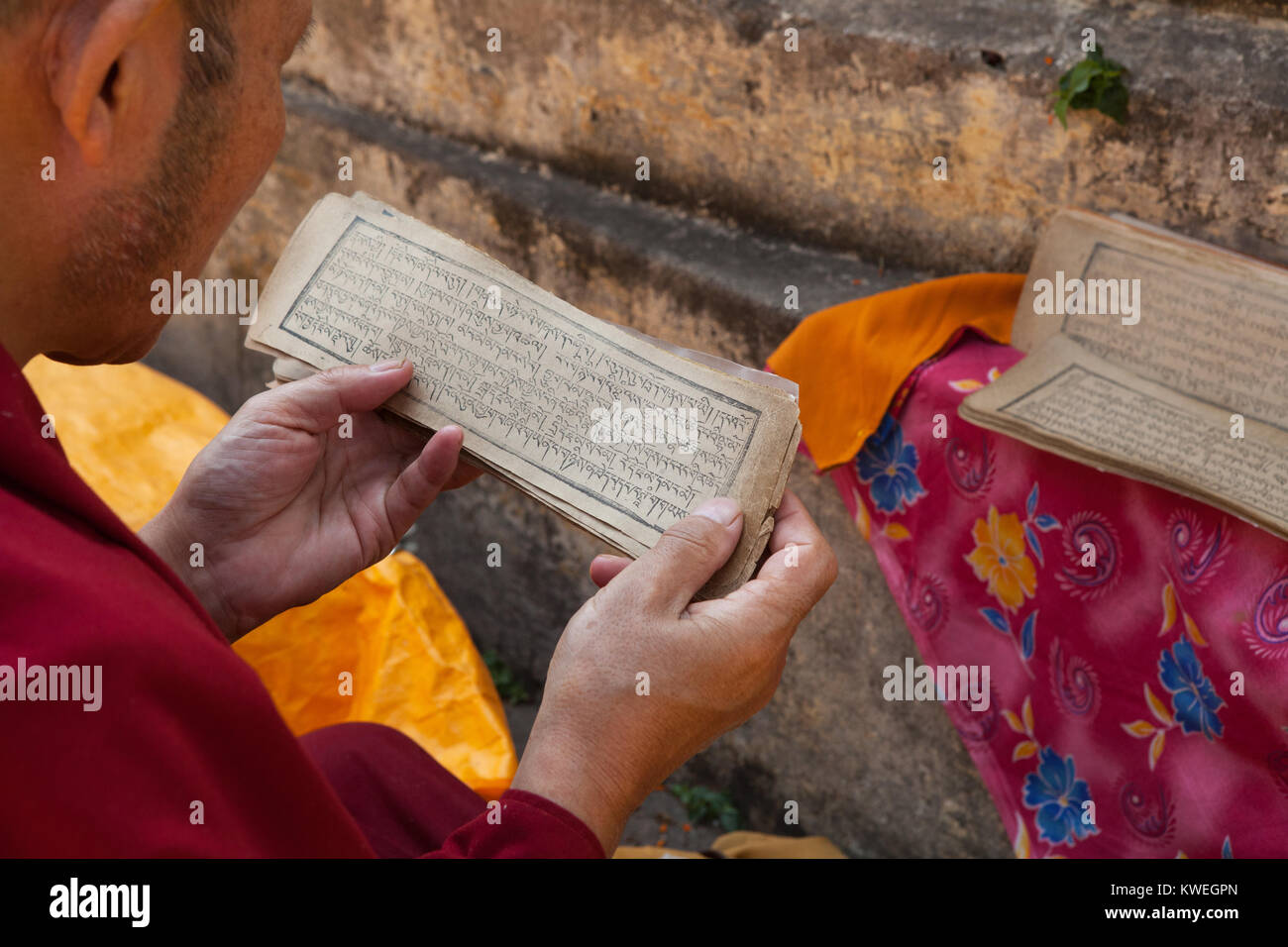 A monk reads a Tibetan prayer card at the Mahabodhi Temple in Bodhgaya ...