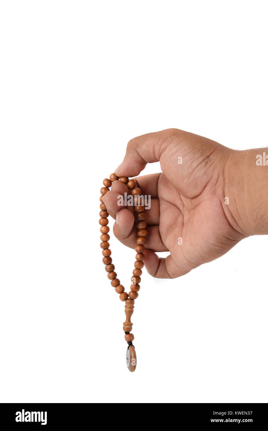 Muslim male hands holding rosary on white background Stock Photo - Alamy